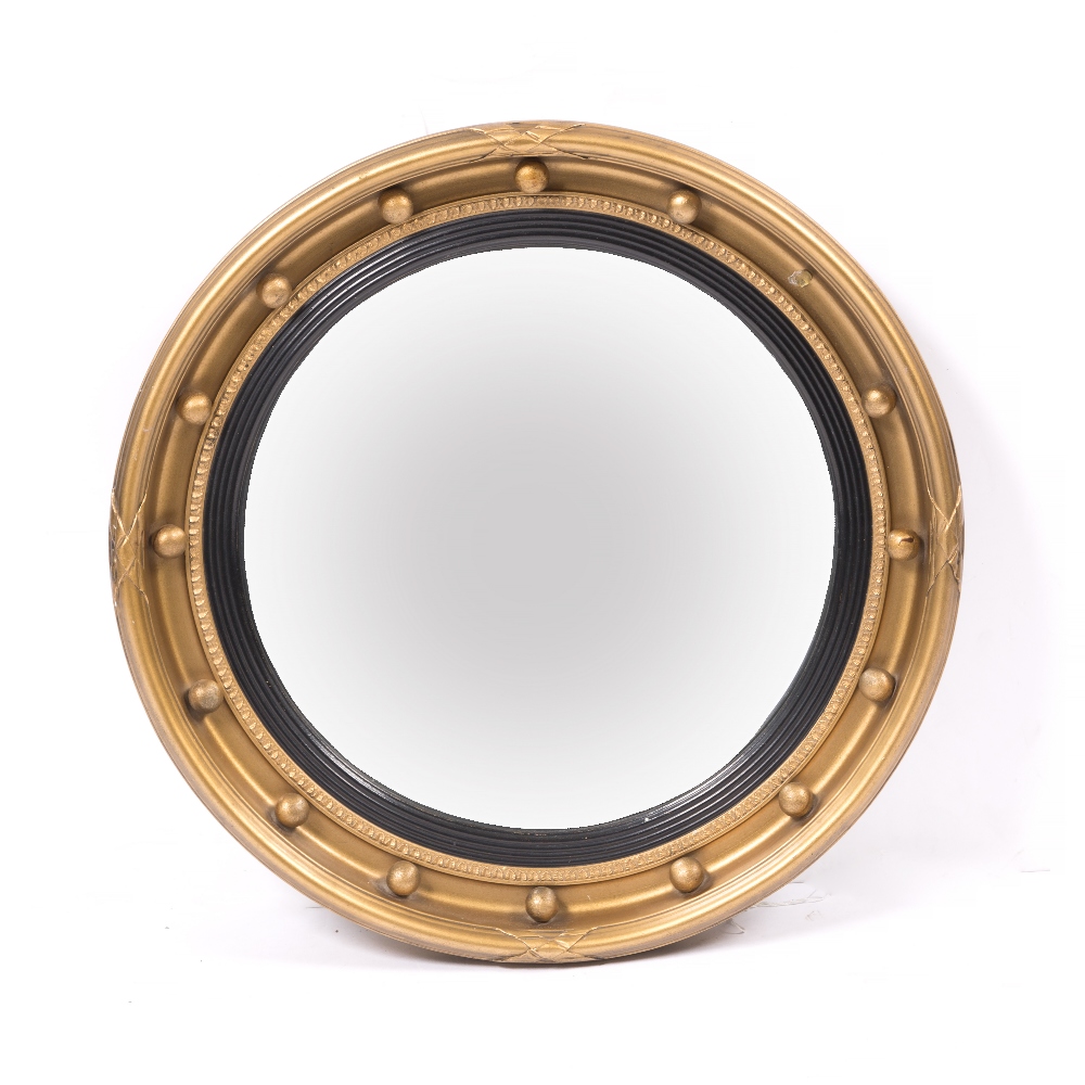 Lot 14 - A gilt convex wall mirror